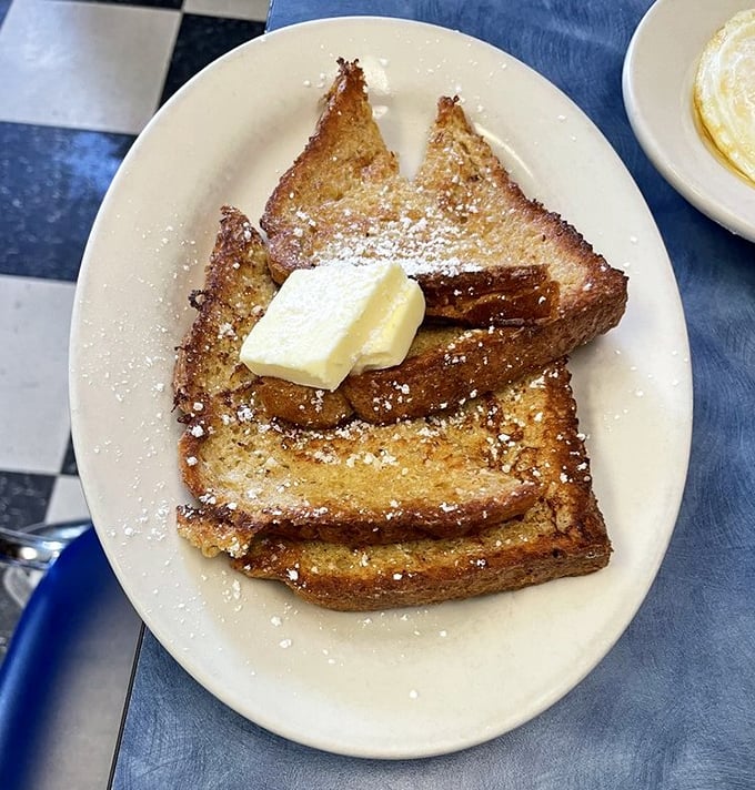 French toast that's crisp-edged and tender-centered, dusted with powdered sugar and topped with butter – the breakfast equivalent of a warm hug.