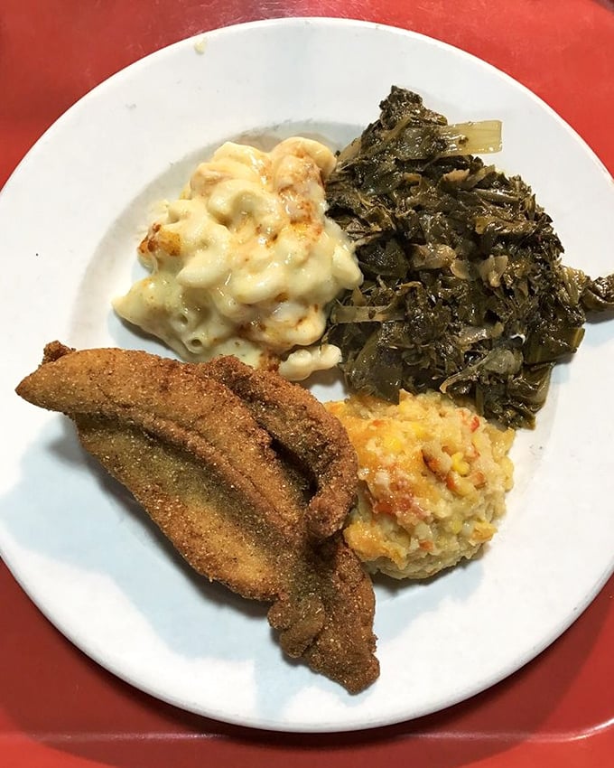 Crispy cornmeal-crusted catfish meets creamy mac and cheese and collards—the holy trinity of Southern comfort on a plate.