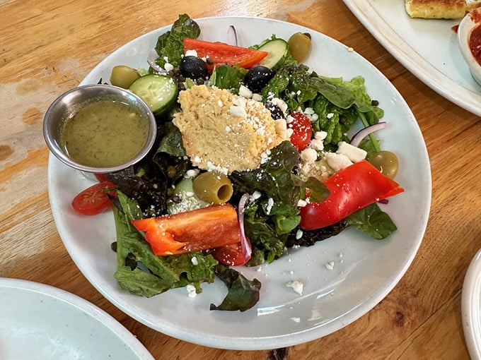 A Greek salad that actually tastes like something—crisp vegetables, briny olives, and a generous crumble of feta with house-made dressing.