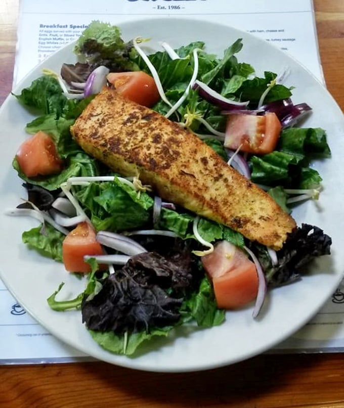A grilled salmon salad for those who want to pretend they're being virtuous while still experiencing maximum flavor satisfaction.