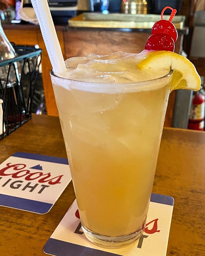 This refreshing cocktail with its cherry garnish and lemon slice isn't just a drink—it's liquid vacation in a glass.