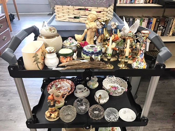 This cart of collectibles tells a hundred stories – each porcelain figurine and crystal dish waiting for its next chapter.