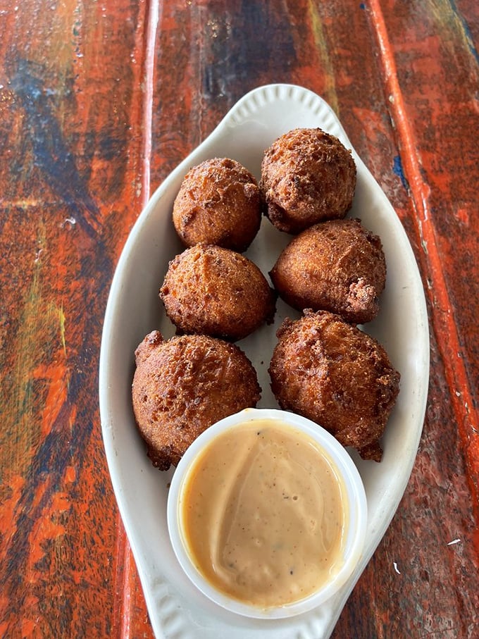 Hush puppies that speak volumes—golden-brown spheres of cornmeal perfection with a soft, fluffy interior worth breaking the silence for.