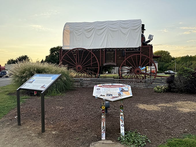 The informational display offers context, but let's be honest—you're here because you spotted a giant Lincoln reading atop a massive wagon from the highway.