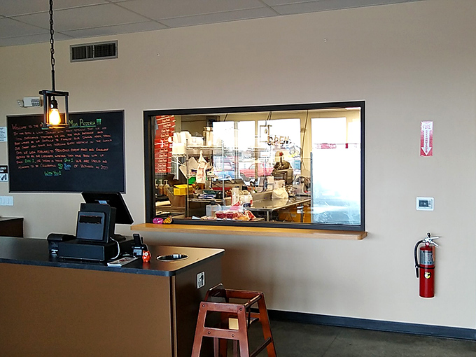 The kitchen window offers a glimpse into the promised land—where dough becomes destiny and sauce becomes salvation.