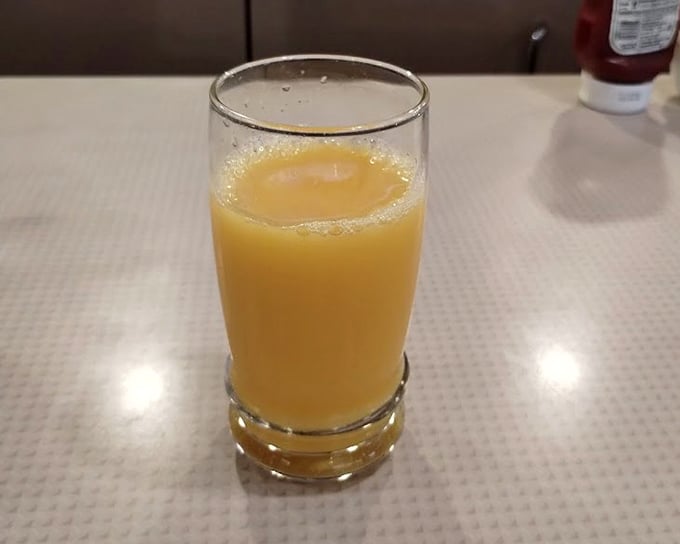 Orange juice so fresh it makes you wonder if they're hiding an orange grove somewhere behind the kitchen. Morning sunshine in a glass.