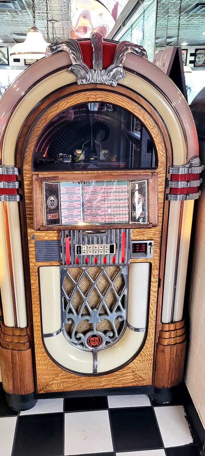 That jukebox isn't just playing songs—it's a time portal disguised as furniture. Push a button and suddenly you're dancing in another decade.