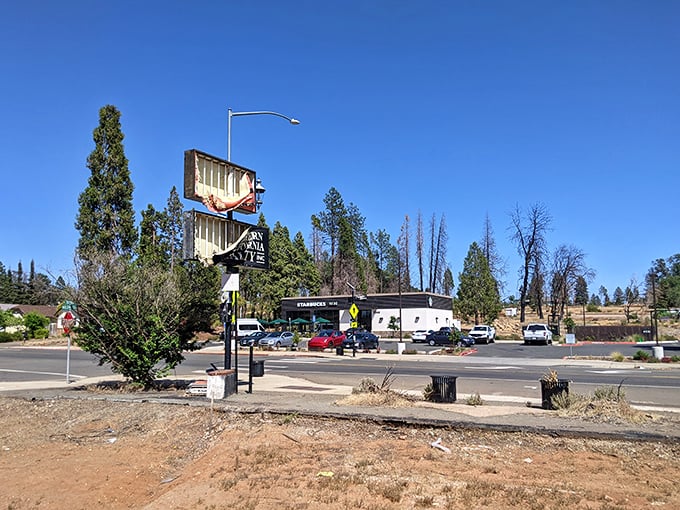 Main Street shows signs of renewal amid blue skies and pine trees. Each reopened business represents another stitch in the fabric of this recovering community.