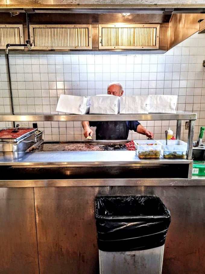 Behind the counter, sandwich artistry happens with practiced precision. Those wrapped packages aren't just lunch—they're edible treasures worth the pilgrimage.