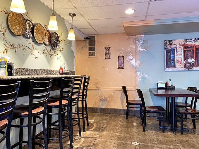 Bar seating with a view of painted landscapes – where solo diners become philosophers over pizza slices.