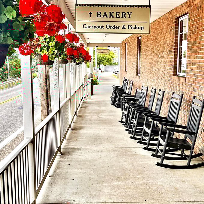 The front porch, lined with rocking chairs and vibrant flowers, invites you to slow down and savor the moment – a preview of the unhurried meal to come.