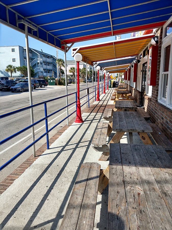 Outdoor seating where sea breezes enhance every bite. These weathered wooden benches have stories to tell—if only they could talk between meals.
