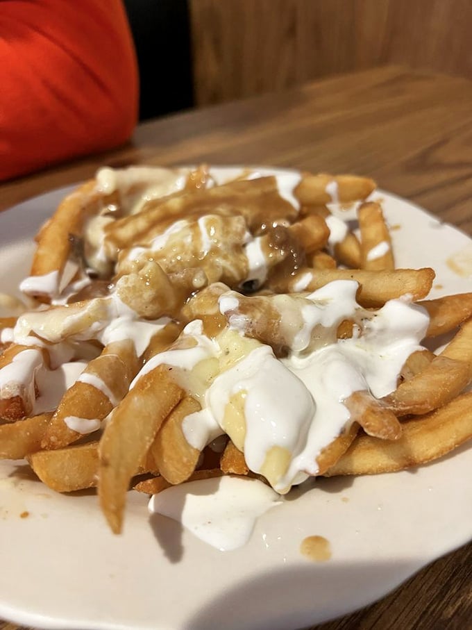 Poutine that doesn't need a passport – crispy fries swimming in gravy and cheese curds that would make a Canadian nod in approval.