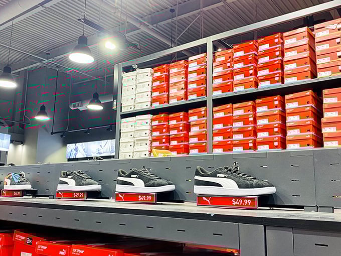 The wall of Puma sneakers and their orange boxes – like a museum exhibit dedicated to the art of athletic footwear.