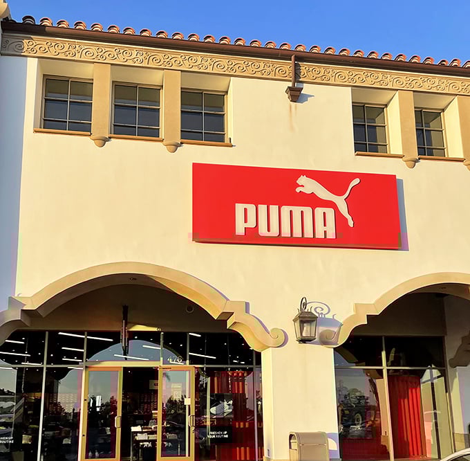 Puma's bold red signage against crisp white stucco—like a siren call to those who want their athletic wear with a dash of European flair.
