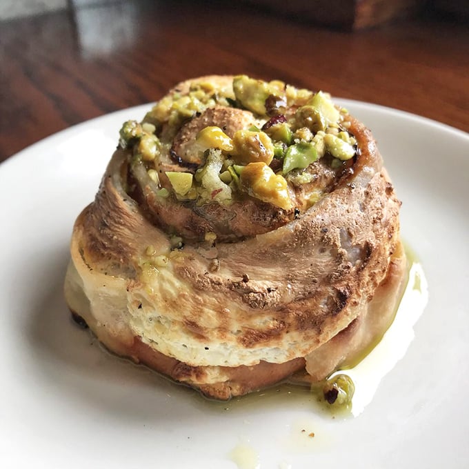 The Rotolo – pizza dough's sophisticated cousin. Spiraled with pistachio and mortadella, it's what happens when pizza goes to finishing school.