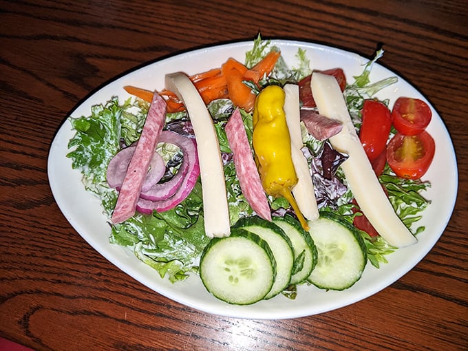 A fresh salad featuring colorful vegetables that provides the perfect lighter counterpoint to all that protein.