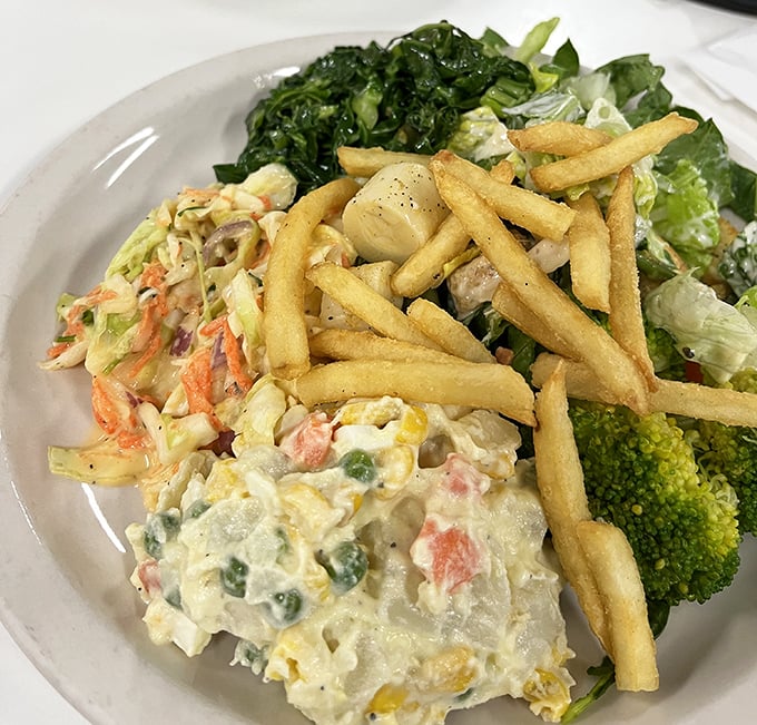 A salad plate that proves Brazilians understand that vegetables deserve respect too—especially when topped with crispy fries for good measure.