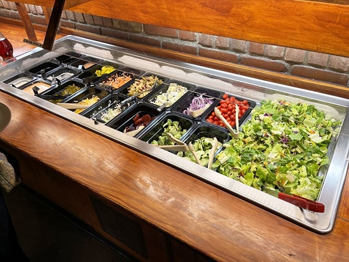 A salad bar that actually deserves respect – fresh ingredients waiting to become the opening act before the meaty main event.