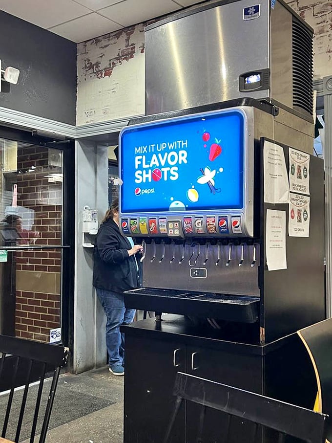 The self-service drink station offers liquid companionship for your pizza adventure. Choose wisely—the right beverage pairing elevates the cold-cheese experience to new heights.