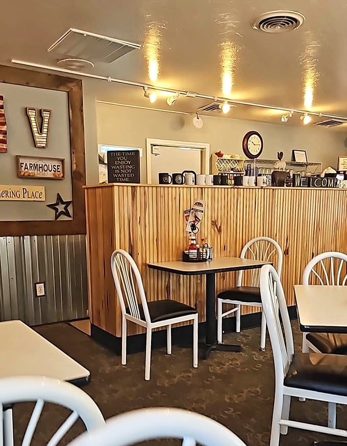 Farmhouse-style decor and wooden wainscoting create that "grandma's kitchen" feeling that makes every meal taste better. Note the "Gathering Place" sign—truth in advertising.