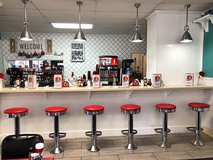 Classic counter seating with fire-engine red stools – where solo diners become temporary members of the breakfast club.