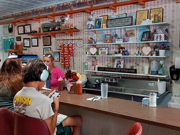 The service counter lined with character: colorful flowers, quirky signs, and everything that makes small-town diners irreplaceable.