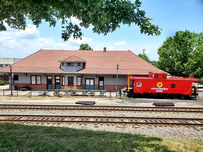 The vibrant red Southern Railway caboose perfectly complements the town's apple obsession—clearly, Cornelia has a favorite color.