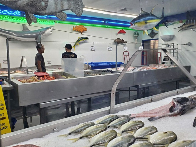The seafood counter showcases the day's catch with mounted trophies overhead—silent reminders of what you could be enjoying if you make the right choice.