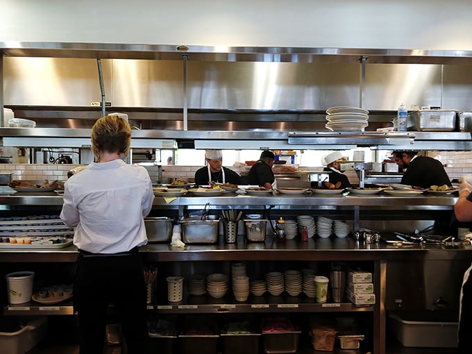 The pass-through window—where dreams become plates and the staff works with the precision of NASA engineers launching comfort food into orbit.