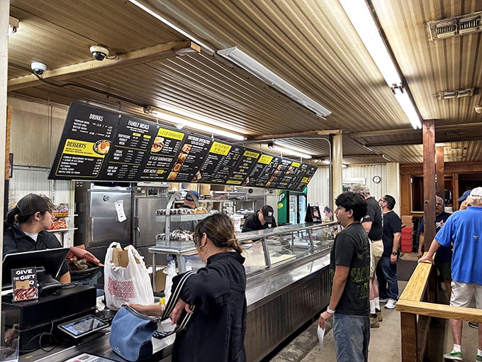 The line moves with practiced efficiency as customers contemplate life's most important question: brisket, sausage, ribs, or the correct answer – all three.