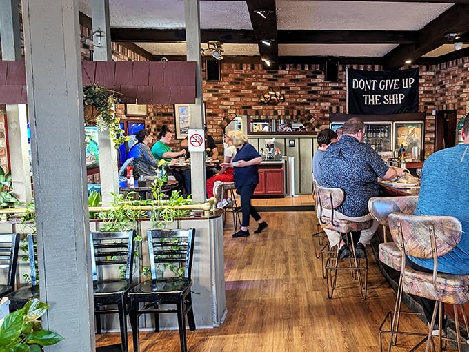 The warm, nautical interior where "DON'T GIVE UP THE SHIP" isn't just decor—it's solid advice when facing that generous seafood platter.