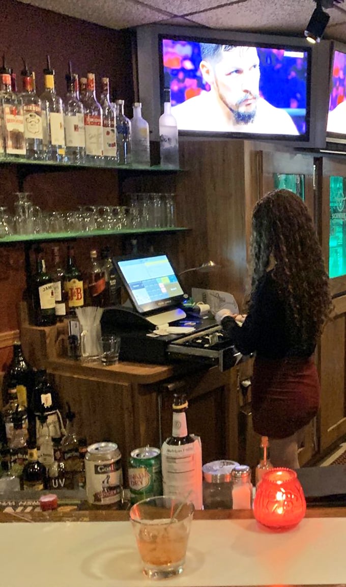Hospitality in action. The bar staff efficiently prepares drinks while sports play on the overhead screens—a perfect Wisconsin pairing.