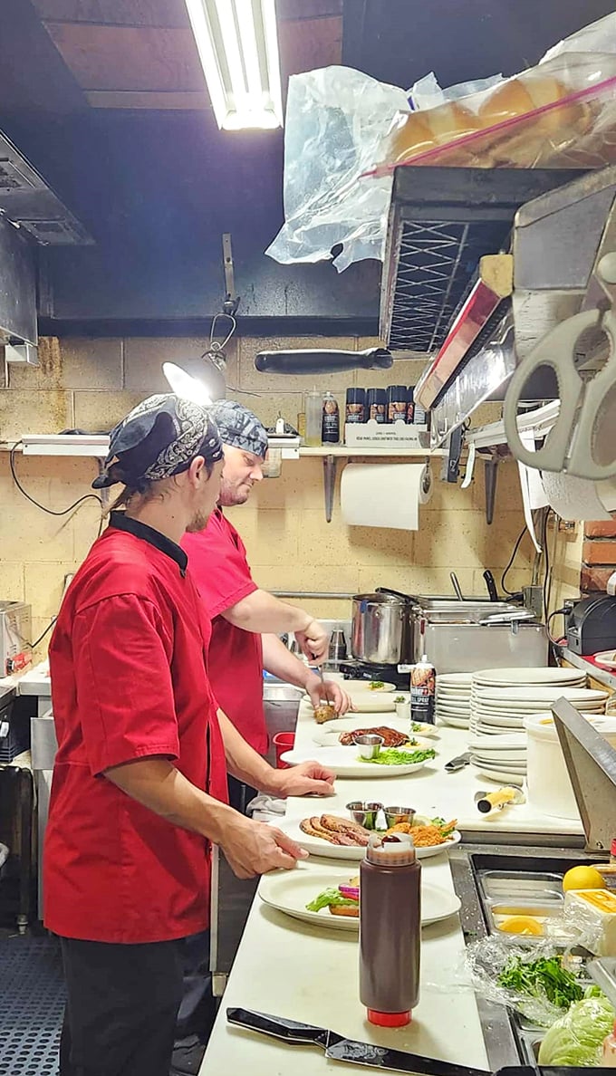 The magic happens here, where skilled hands transform raw ingredients into memories. No tweezers or molecular gastronomy—just honest cooking with fire and skill.