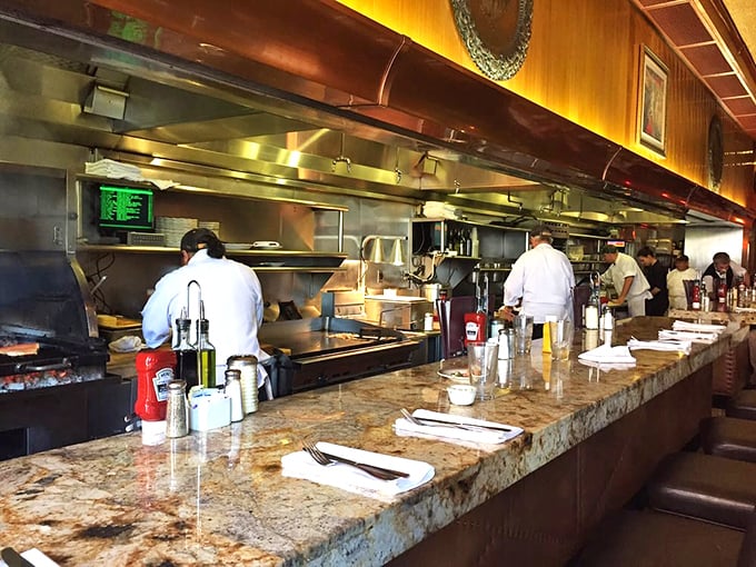 The open kitchen isn't just functional – it's dinner theater where chefs perform the ancient art of turning ingredients into memories.