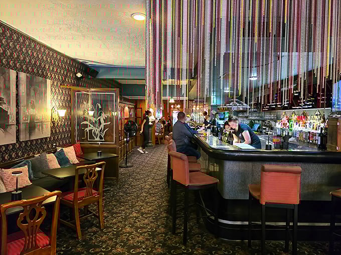 Those beaded curtains and pink bar stools aren't just decor—they're time portals to when The Rat Pack might drop in for dinner.