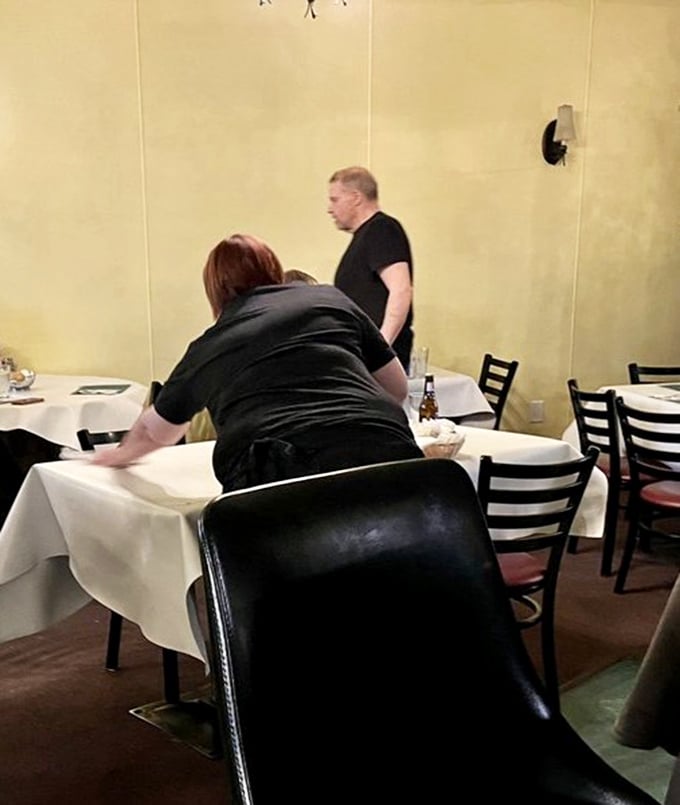 Staff preparing tables with care—the kind of attentive service that comes from pride rather than corporate training manuals.