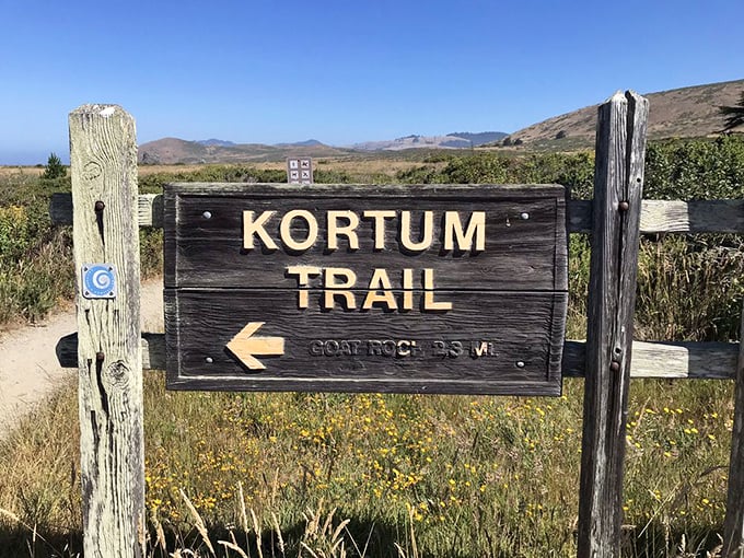 The Kortum Trail sign points toward adventure, promising the kind of views that make even the most jaded hikers stop mid-stride in wonder.