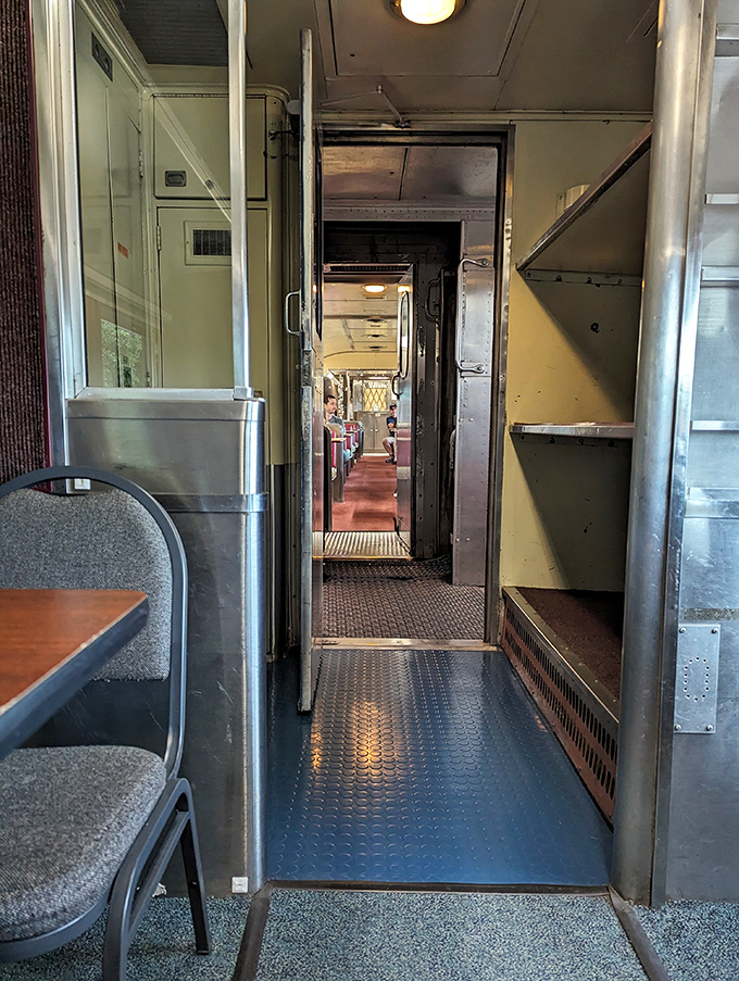 Narrow passageways between train cars reveal the elegant functionality of vintage rail design—every inch purposeful, every detail considered.