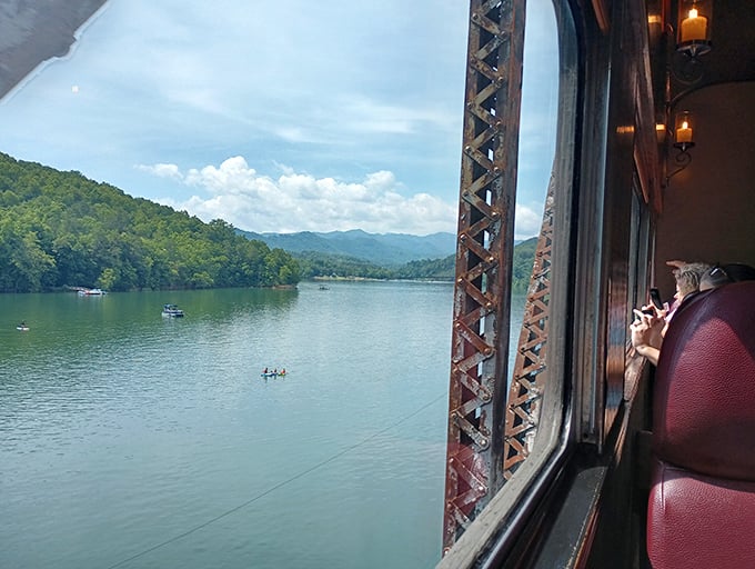 Window to wilderness – the view that no highway can deliver. Passengers glimpse serene mountain lakes from the comfort of vintage coaches.