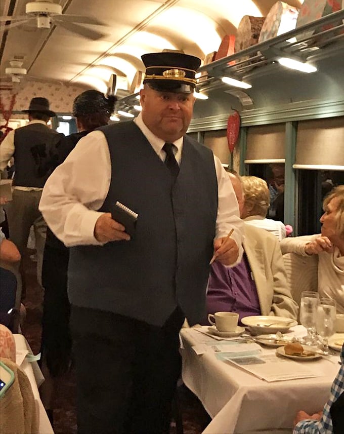 All aboard for mystery! The conductor isn't just staff—he's part of the immersive experience, setting the stage for theatrical dining.