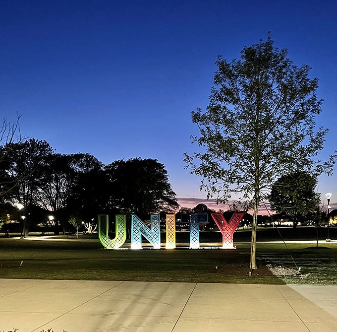 Unity Park's illuminated letters glow against the twilight sky, spelling out Greenville's community spirit that welcomes retirees like old friends.