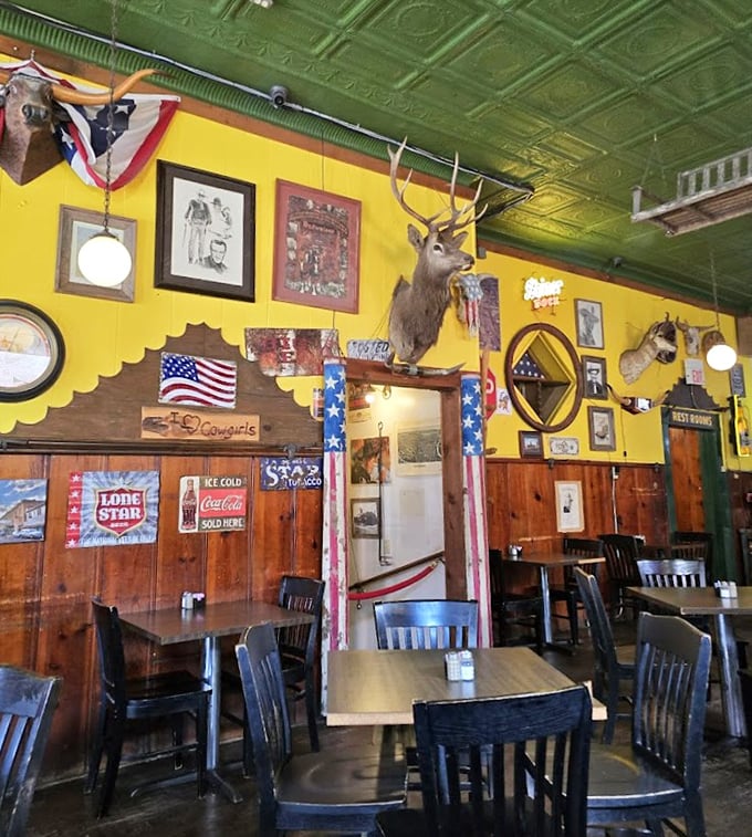 Yellow walls, green ceiling, mounted deer head—this isn't interior design, it's a Texas personality test. And everyone passes.
