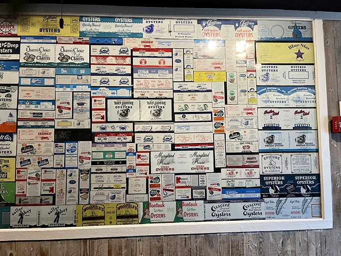 This wall of vintage oyster boxes isn't just decoration—it's a museum of Chesapeake Bay history, each label telling stories of watermen and their harvests.