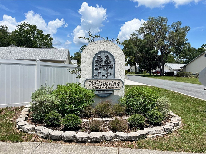 Whispering Pines Villas welcomes residents with a sign that might as well say, "Your fixed income goes further here than in those fancy coastal towns."