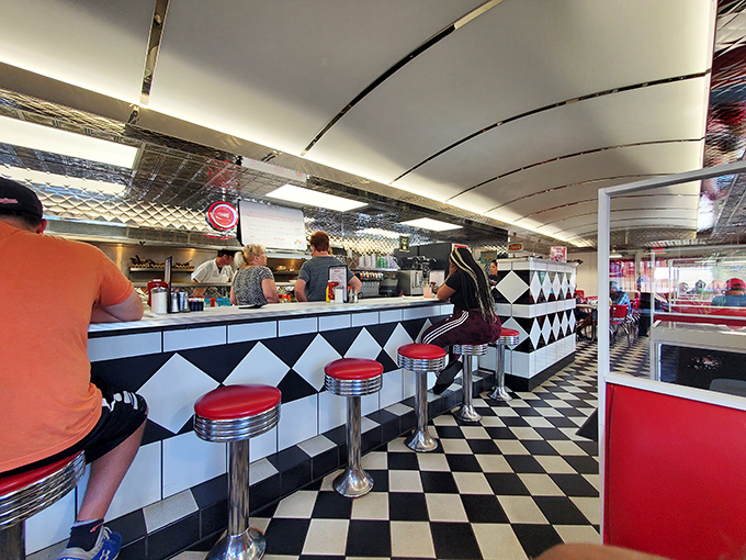 Chrome, checkered floors, and red vinyl—the holy trinity of diner design that signals you're about to eat something wonderfully unpretentious.