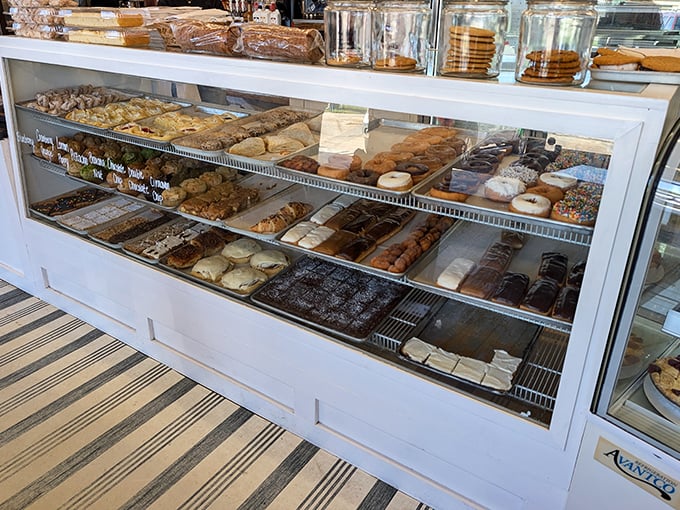 This display case isn't showing pastries—it's exhibiting edible art that makes choosing just one feel like Sophie's Choice: Bakery Edition.