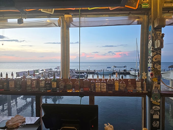The bar at sunset—where the bottles line up like soldiers guarding the view. This is the Florida that postcards can only hint at.