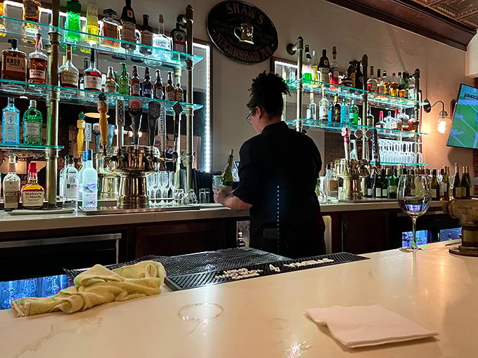 The bar at Shaw's isn't just stocked – it's a liquid library of possibilities, with bottles glowing like treasures in a cave.