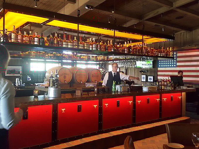 The bar's bourbon collection stands at attention like amber soldiers, ready to report for happy hour duty.